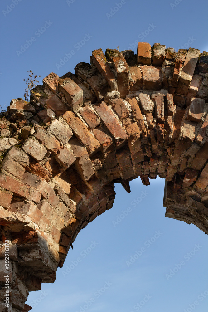 Antique brick arch against the blue sky, old architectural monument ...