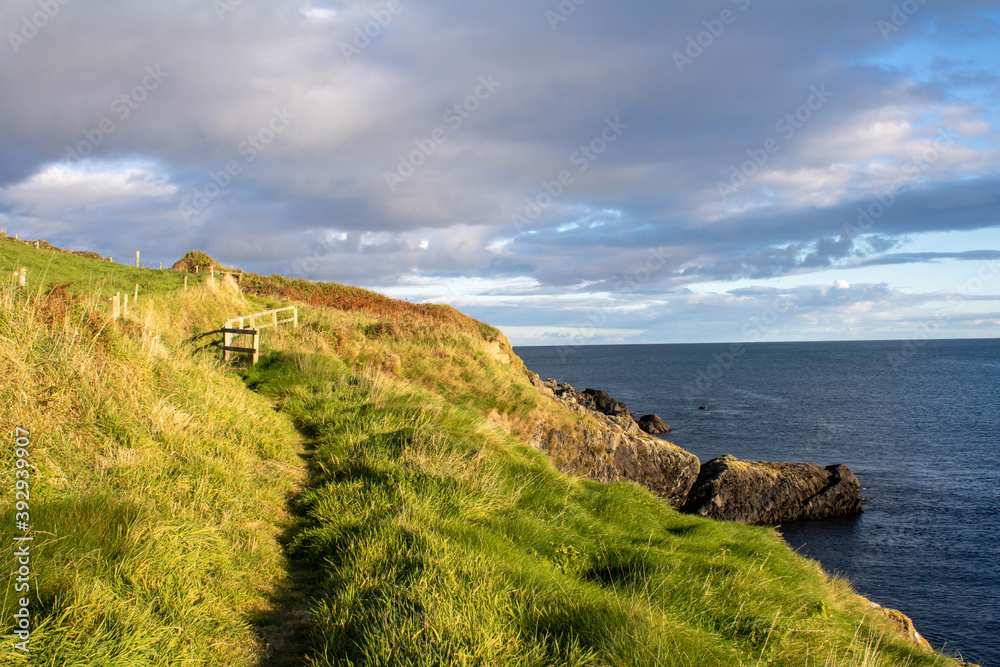 Hiking along the coastal cliffs of West Cork Ireland. Mark and unmarked ...