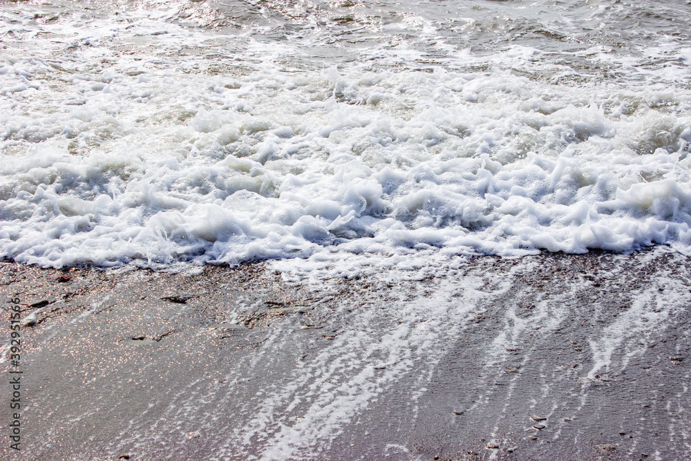 Stormy sea. Gray-blue, cloudy. Foam waves beat on the shore, rocks, breakwaters. Cloudy weather ...