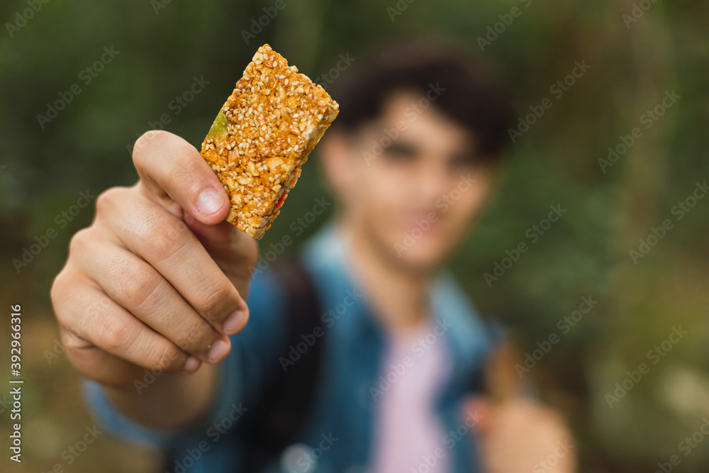 Young man eating a candy bar - Young man showing off his candy bar ...