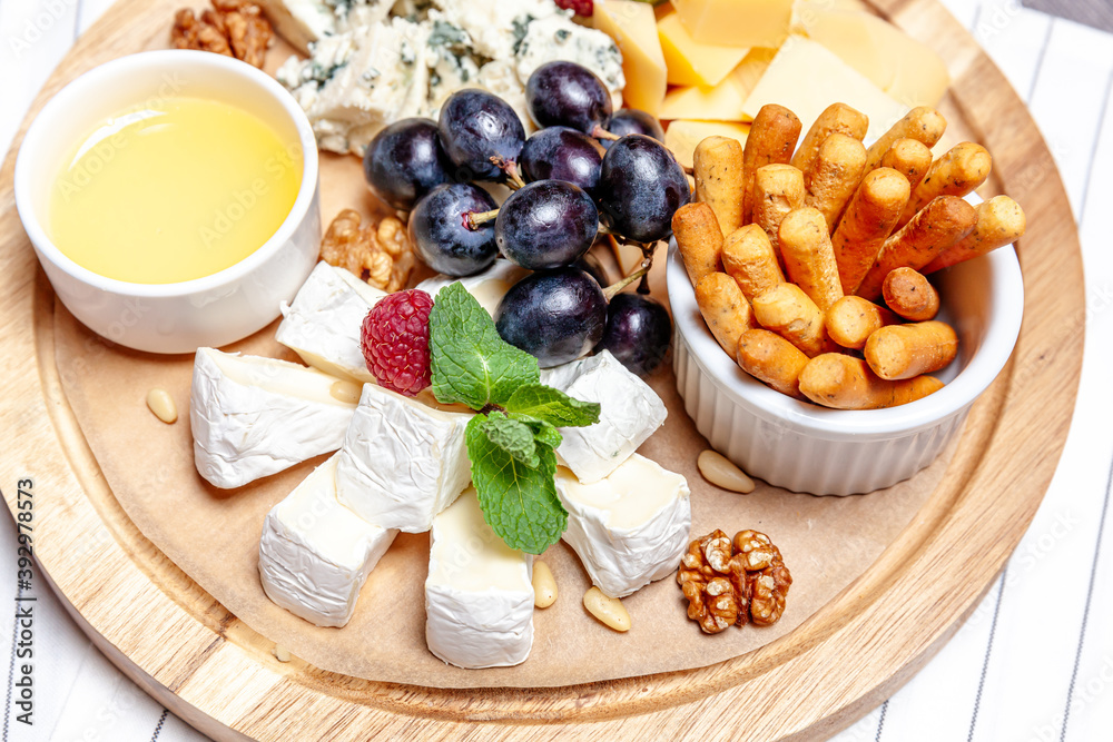 Board with different types of cheese. Cheeses mix set dor blu chedar ...