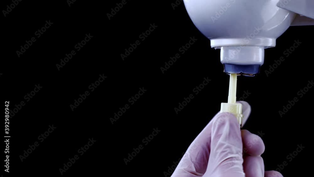 Doctor is installing dropper system and injecting medicine by the ...