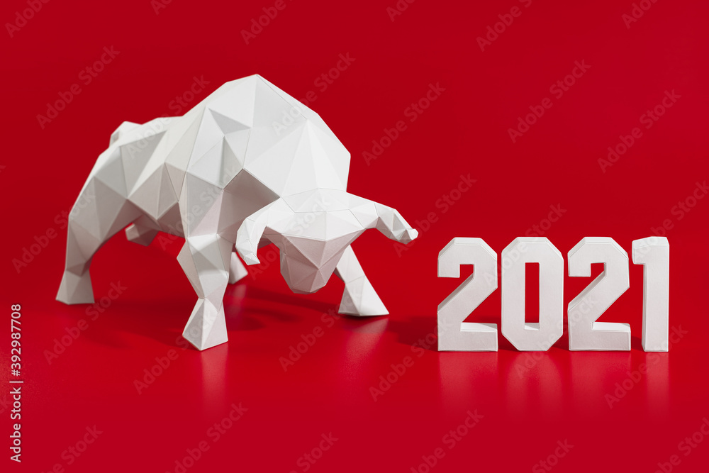 White volumetric paper bull papercraft and numbers 2021 on a red ...
