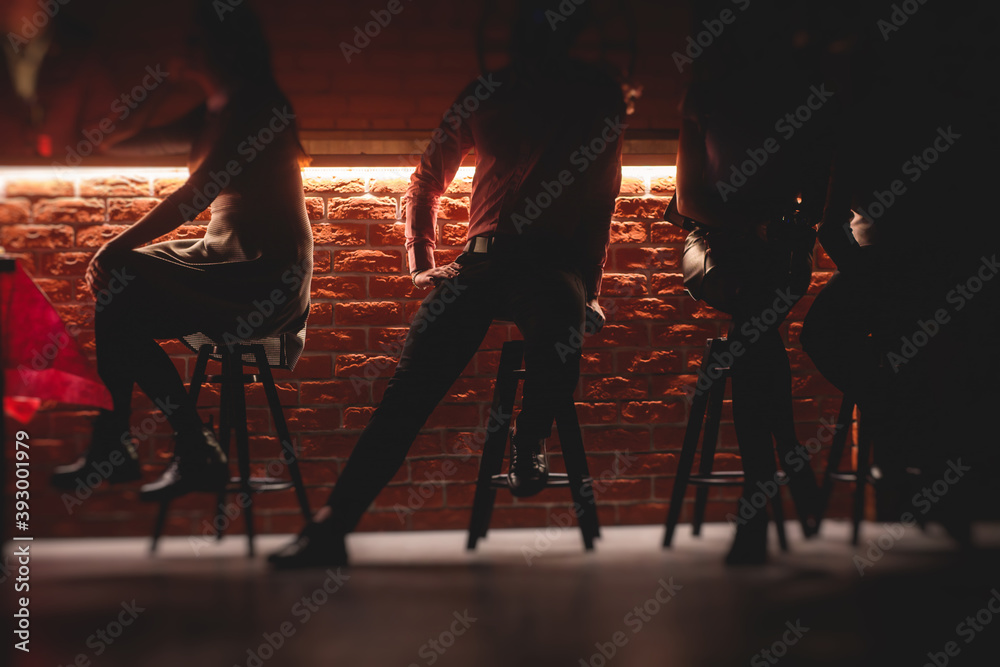 View of pub interior with people silhouettes drinking alcohol beverages ...