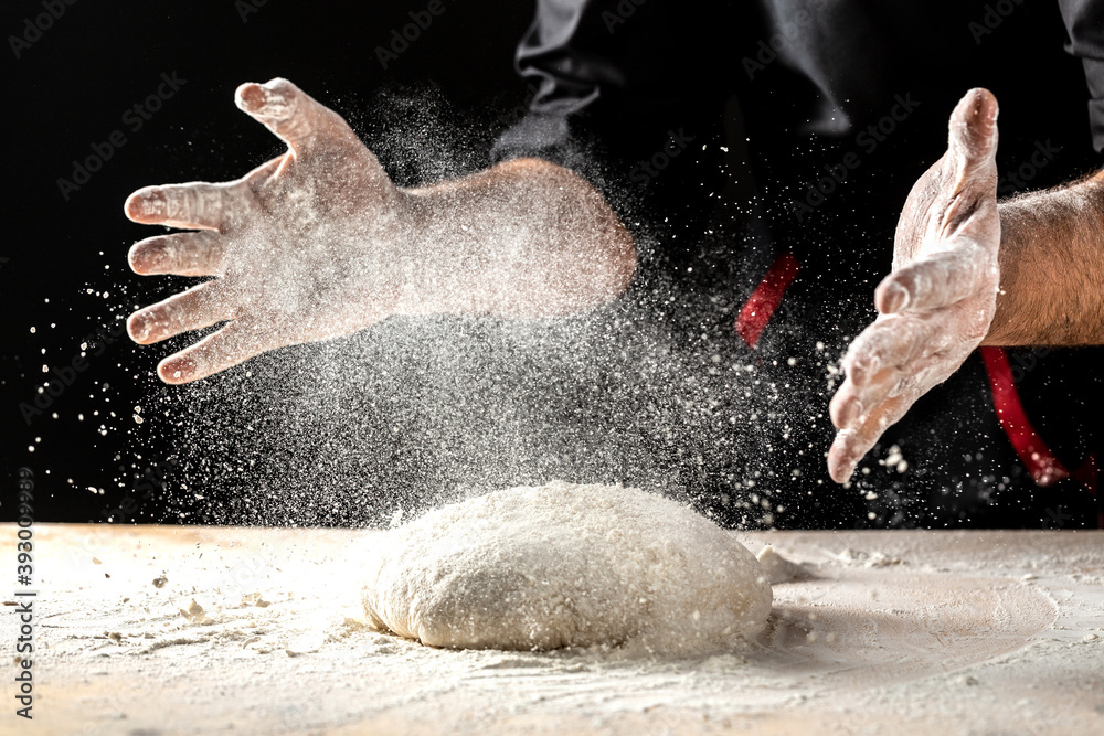White flour flying into air as pastry chef in white suit slams ball ...