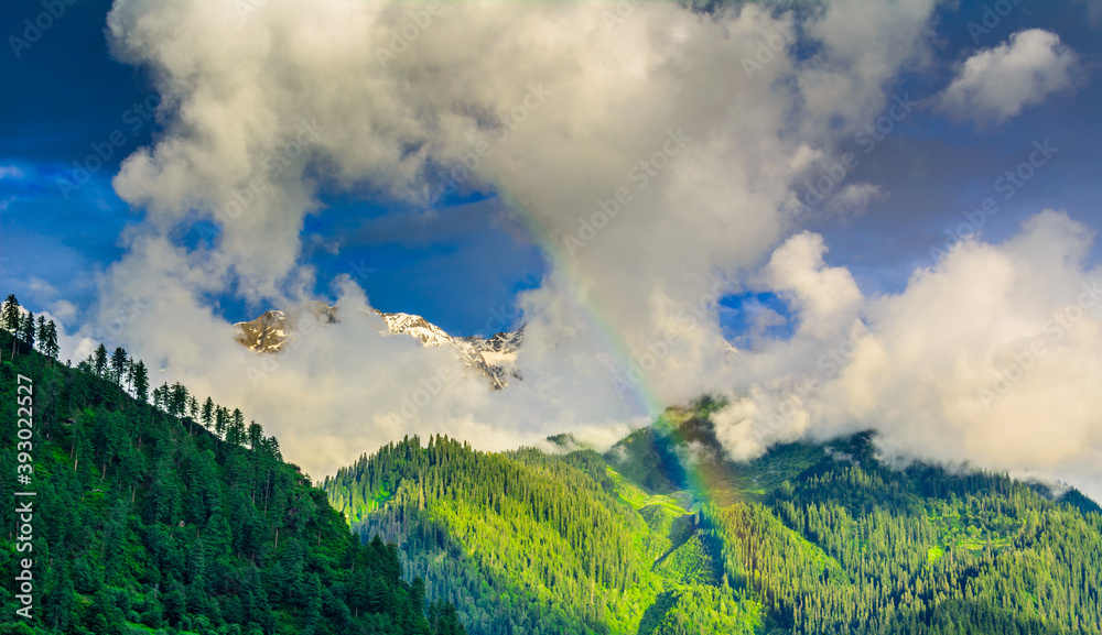 Clouds and Rainbow over the Himalayan mountain in Himachal Pradesh ...