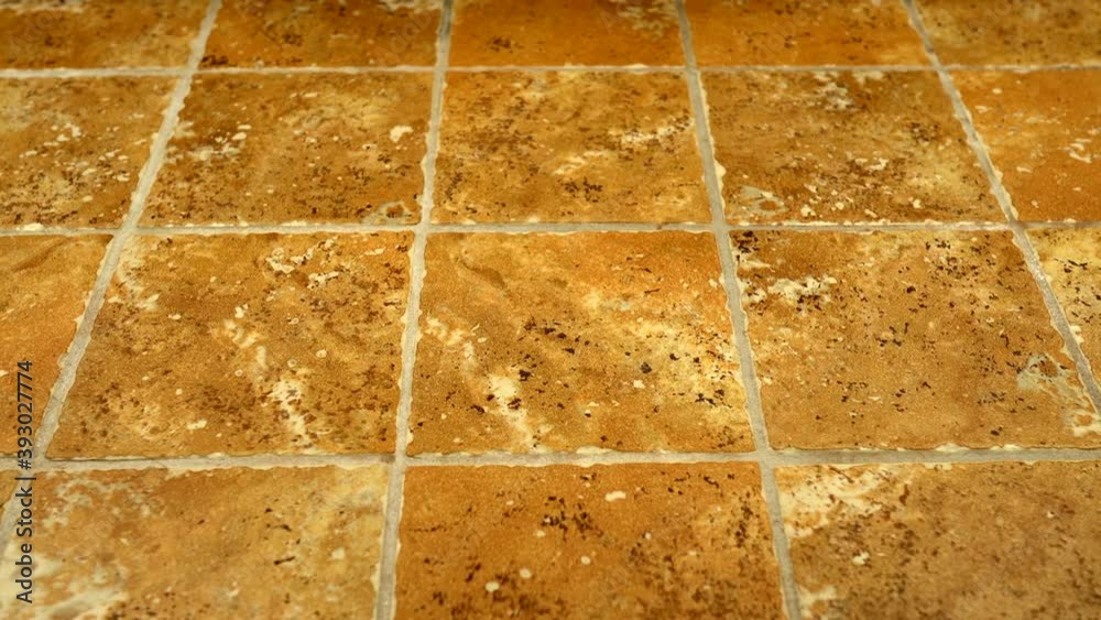 Installed ceramic floor tiles - brown and yellowish textures. Square ...