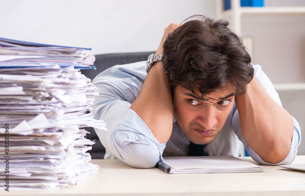 Overloaded busy employee with too much work and paperwork Stock Photo ...