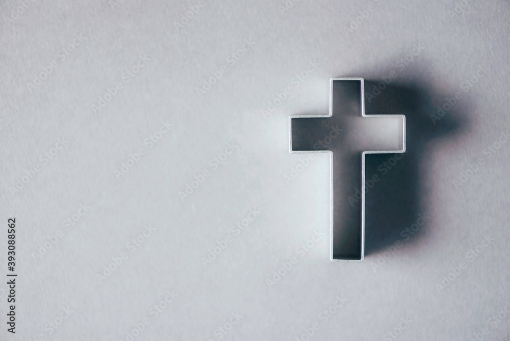 Silhouette of christian cross on grey background, soft bokeh lights ...