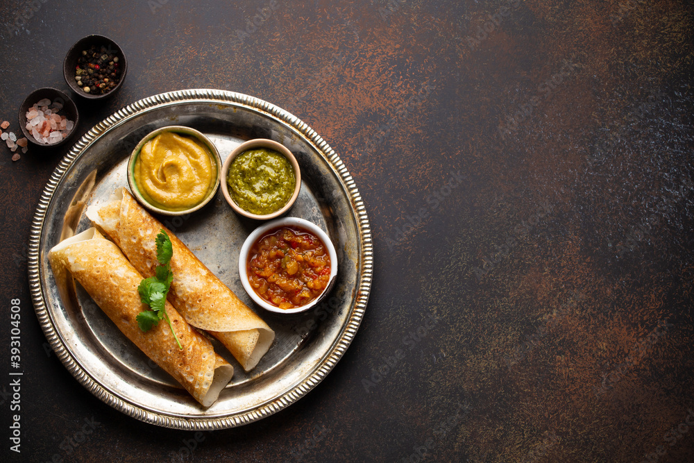 Traditional Indian rice pancakes Dosa with different dips chutney, on ...