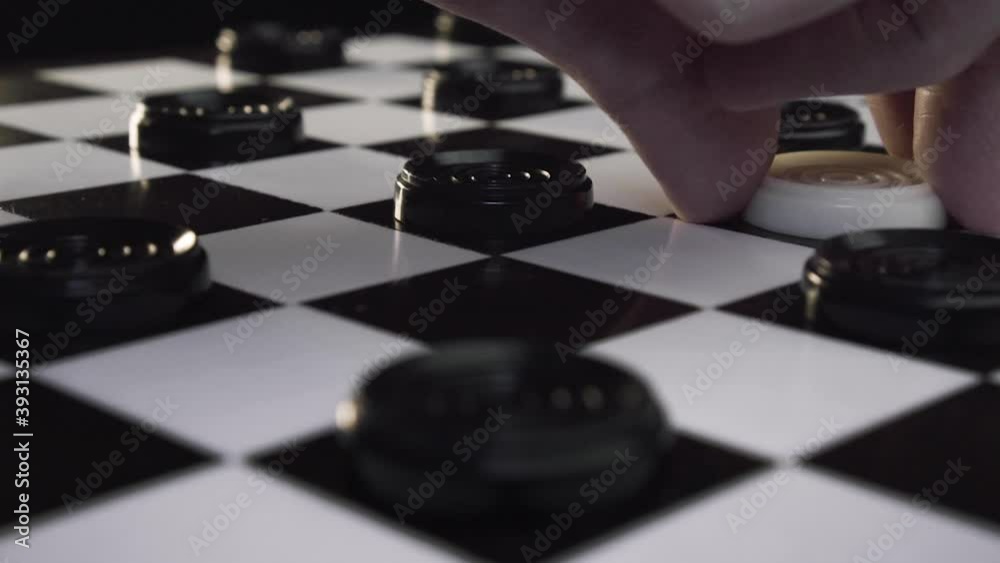 Vídeo do Stock: Checkers - A hand moving a white piece horizontally and ...