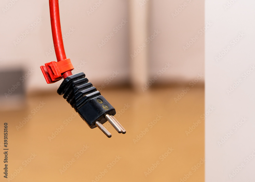 Power cord hanging from the ceiling with blurred and defocused room ...