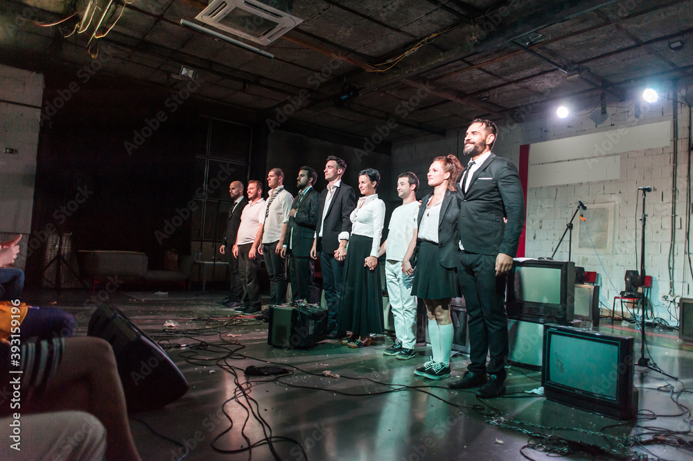 Actors bow to audience on stage after performance. Loud applause from ...