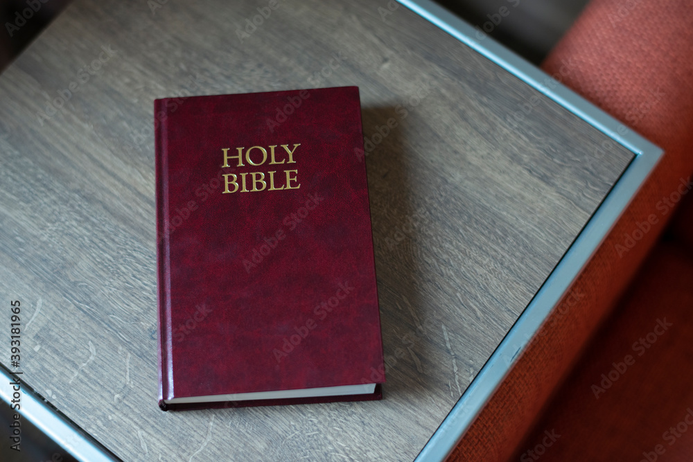 Holy Bible on side table in motel room Stock Photo | Adobe Stock