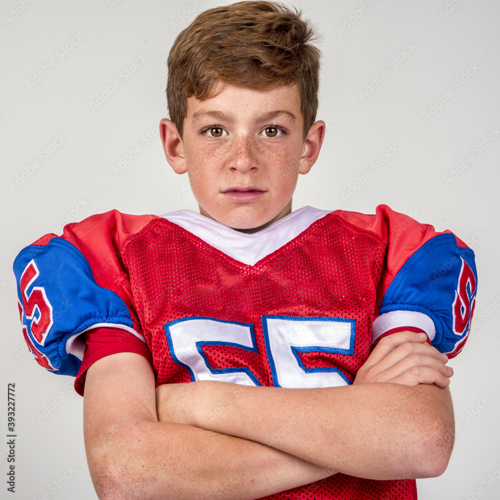 Freckled young football player posing with folded arms Stock Photo ...