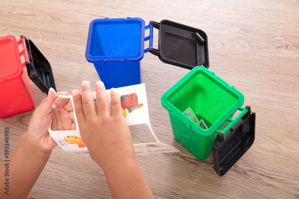 Looking down and shooting, the little girl is learning about garbage ...