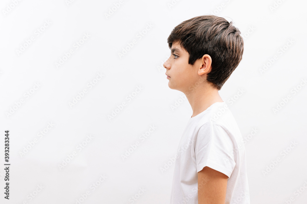 Beautiful kid boy wearing casual t-shirt standing over isolated white ...