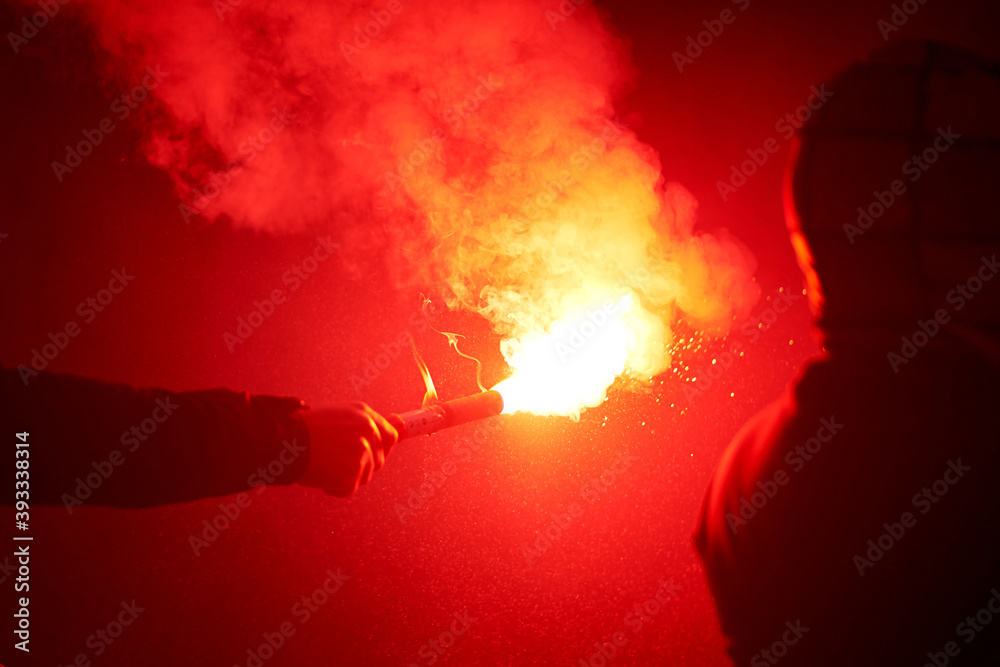 flaming red flare during a street protest in the city Stock-Foto ...