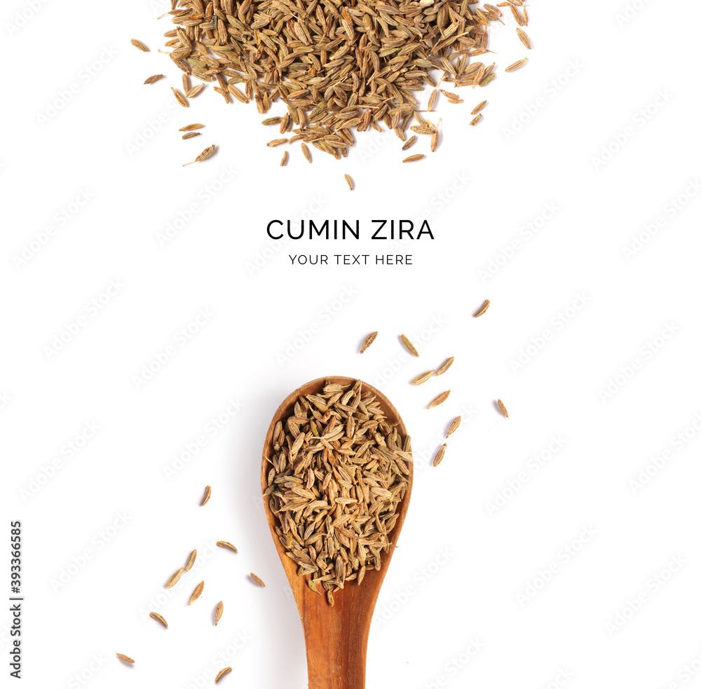 Creative layout made of cumin seeds and wood spoon on a white ...