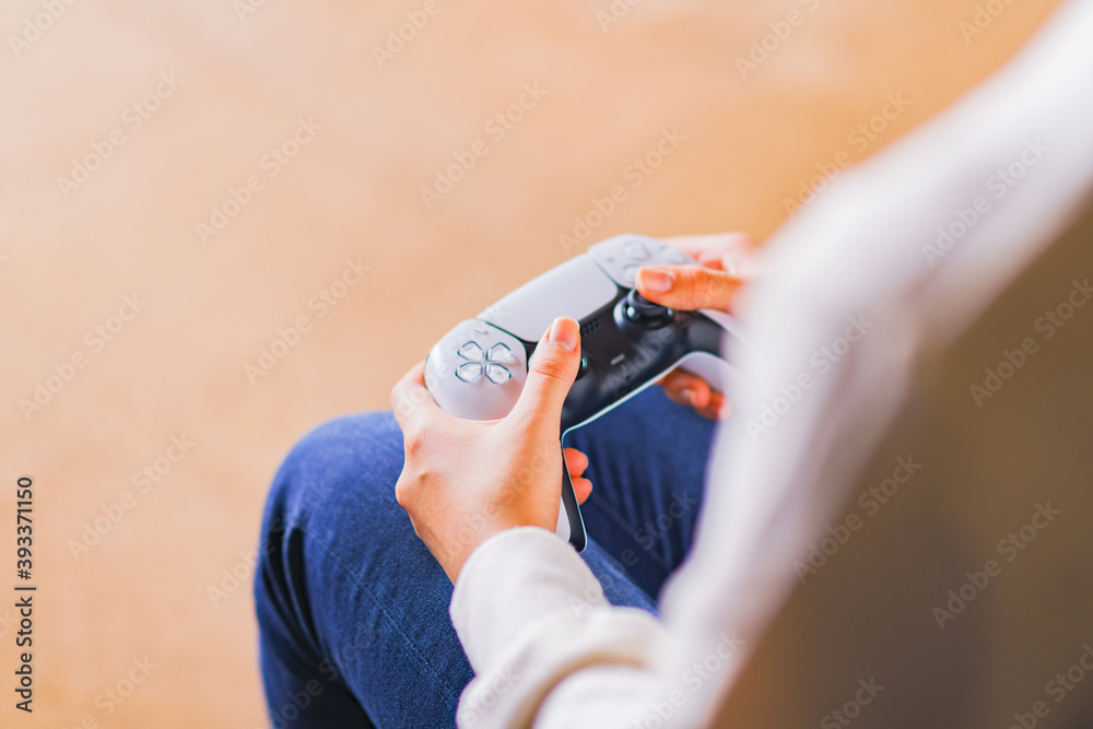 Lifestyle of Japanese girl playing game by using wireless controller ...