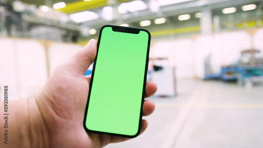 Engineer using Smartphone in Industrial plant with green screen ...