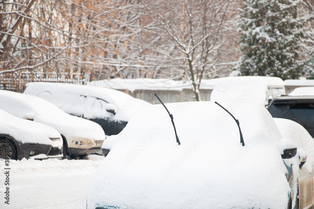 Snow-covered cars in a city parking lot after a snowfall Stock Photo ...
