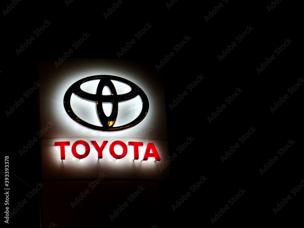 Toyota car dealership signage at night. Toyota Motor Corporation is a ...
