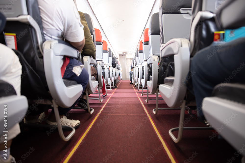 Airplane Aisle with the Passengers Sitting on their Seats Stock Photo ...