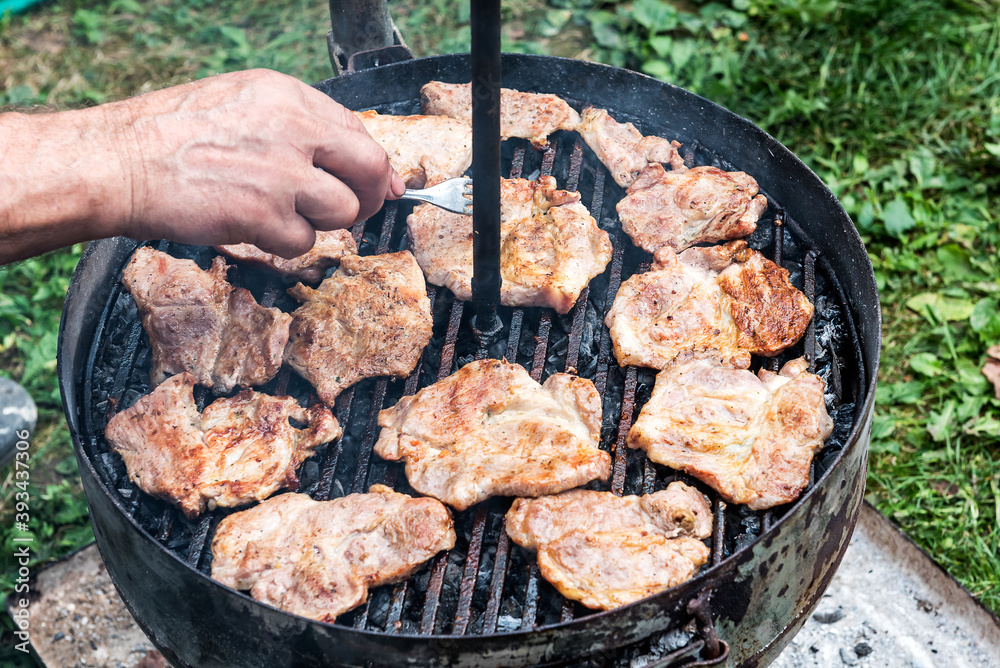 Kettle Charcoal BBQ Barbecue Grill in garden or backyard. Side View of ...