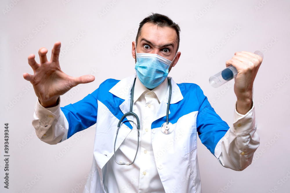 angry doctor with a stethoscope attacks with a big syringe on a white ...