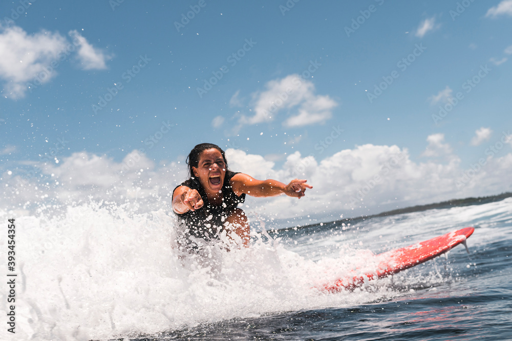 Excited surfer on foamy wave looking at camera on surfboard Stock Photo ...