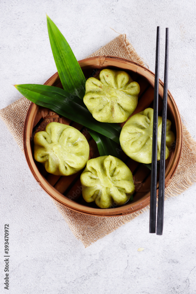 Bakpao or pao or chinese steamed bun in traditional bamboo steamer tint ...