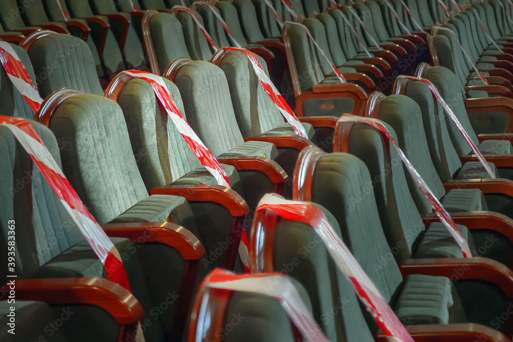 Need to sit on a chair separated by a ribbon in the cinema, theater ...