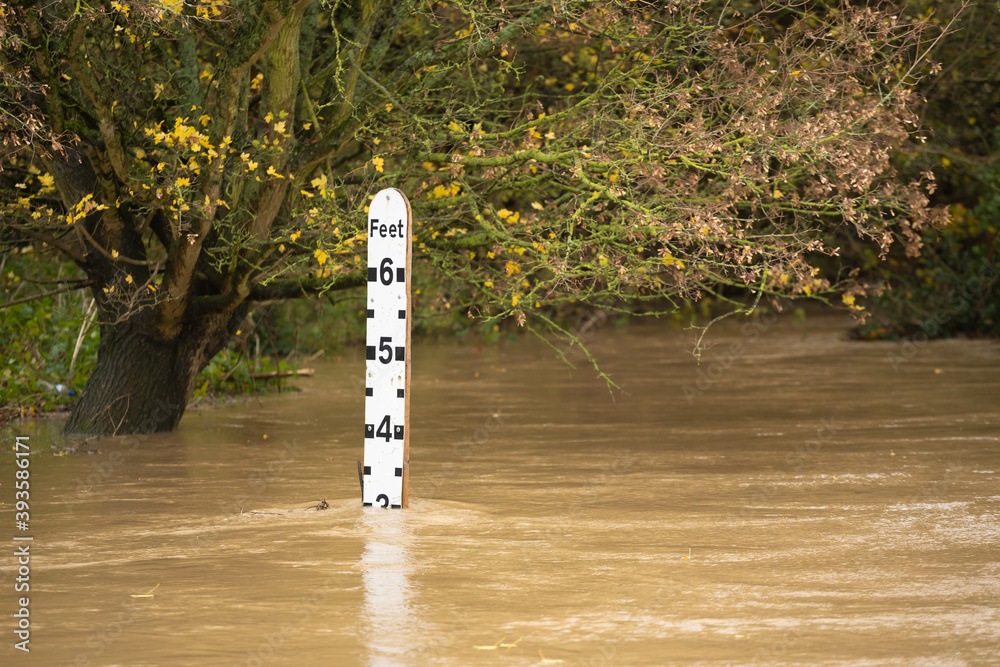 River gauge water level indicator in a flooded river at the ford in ...
