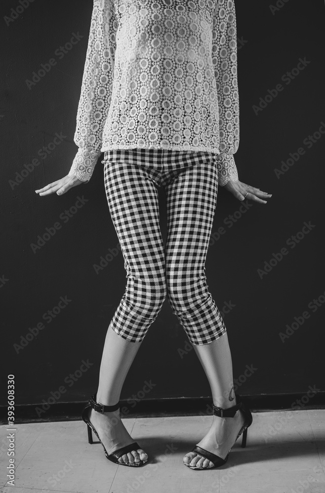 Black and white image of a stylish and elegant woman standing against ...
