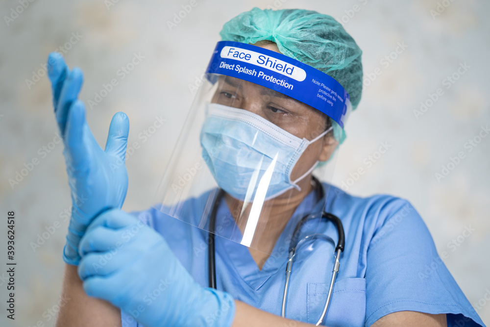 Asian doctor wearing face shield and PPE suit new normal to check ...