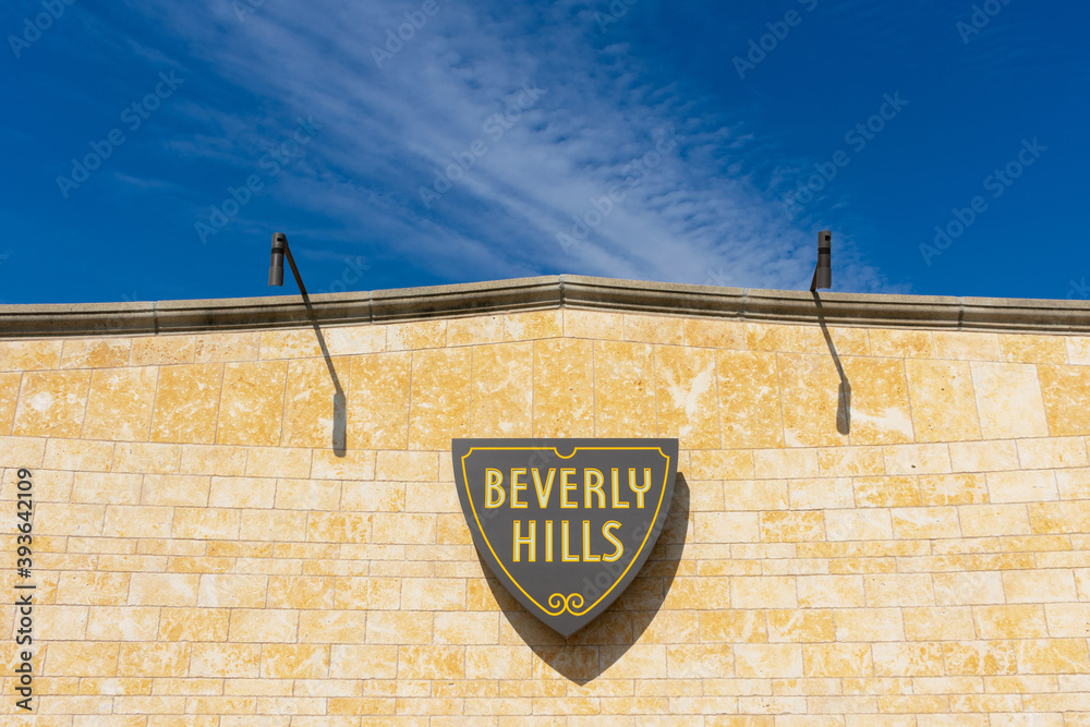 Beverly Hills Shield Sign on the beige wall under beautiful blue sky in ...