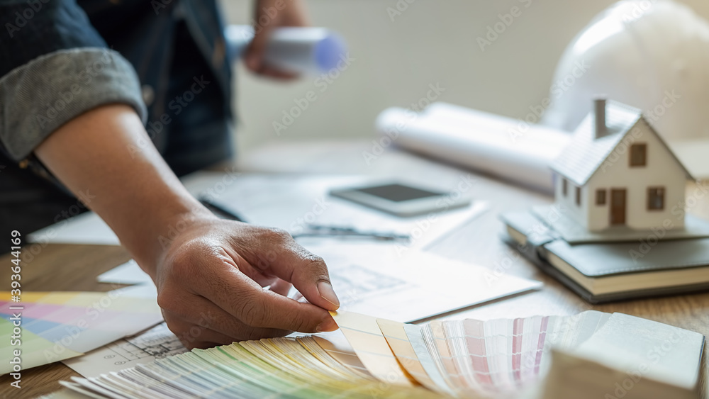 Interior designer choosing color in color swatch samples chart for ...