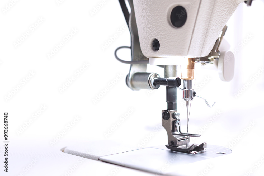 close up on working area of a modern industrial sewing machine equipped ...