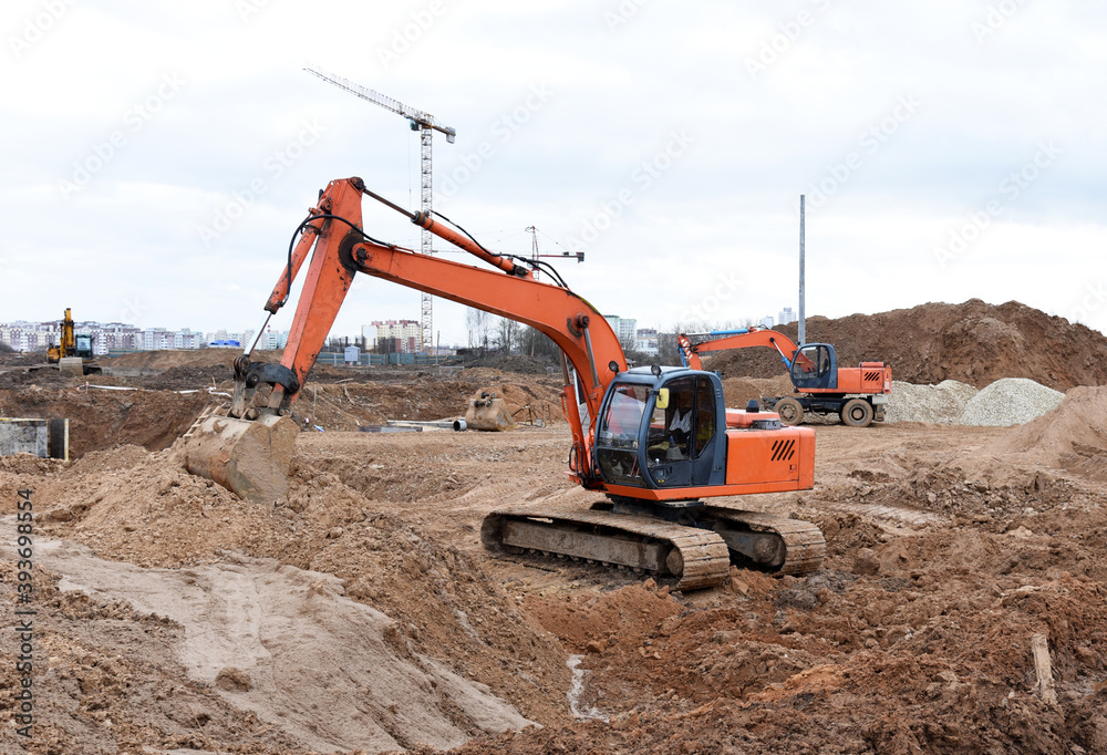 Excavator dig trenches at construction site. Trench for laying external ...