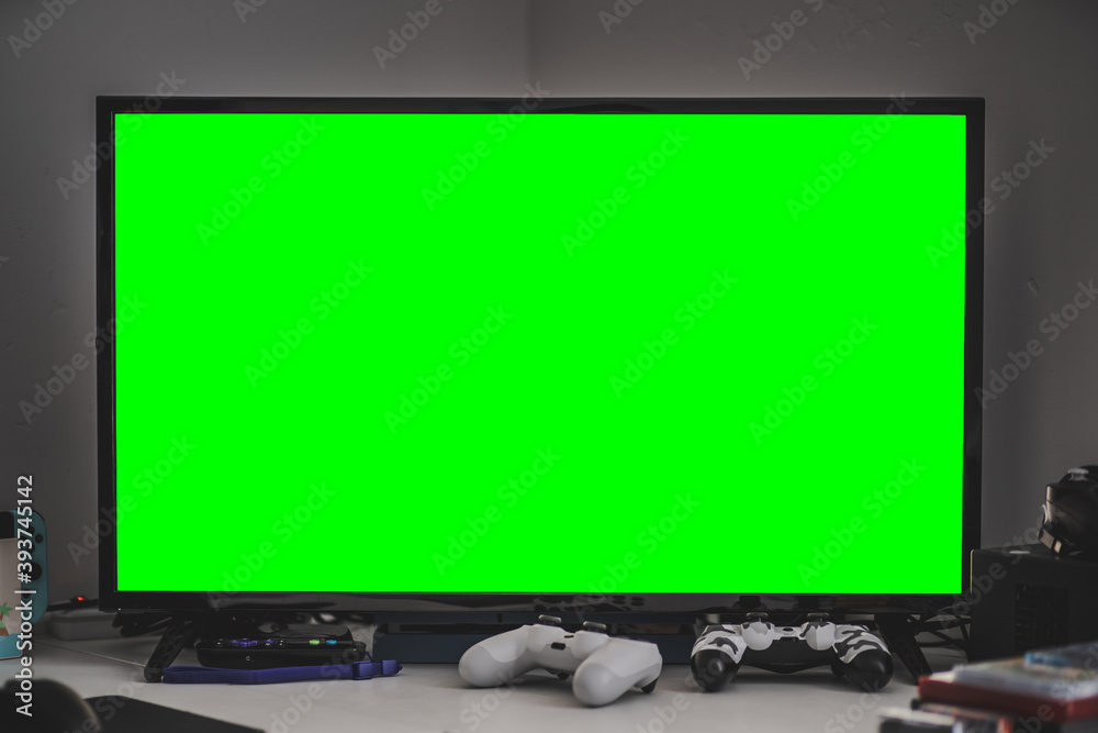 TV w/Green Screen on Desk With Gaming Consoles Stock Photo | Adobe Stock