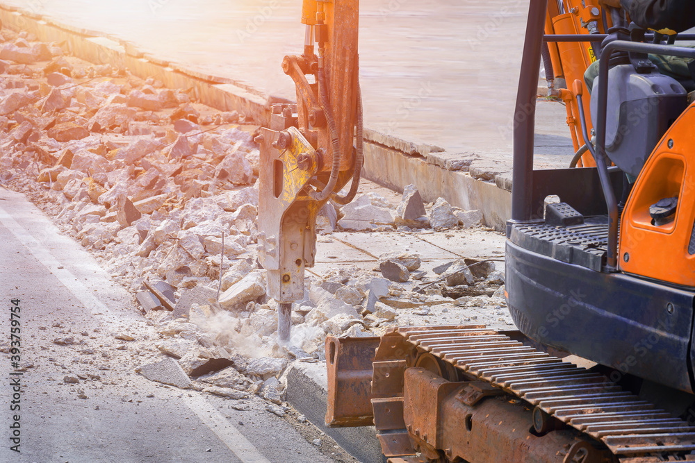 Selective focus at excavator hydraulic crushing hammer is breaking ...