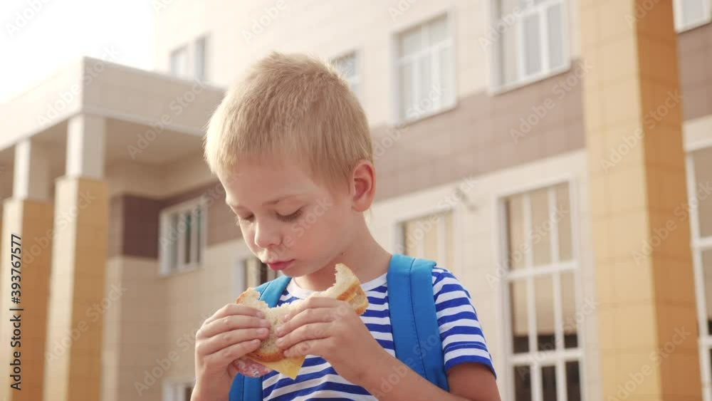 schoolboy eating a sandwich lifestyle during recess in school. kids ...