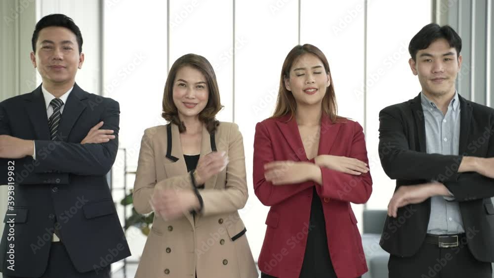 Serious business group posing with arms crossed showing team support ...