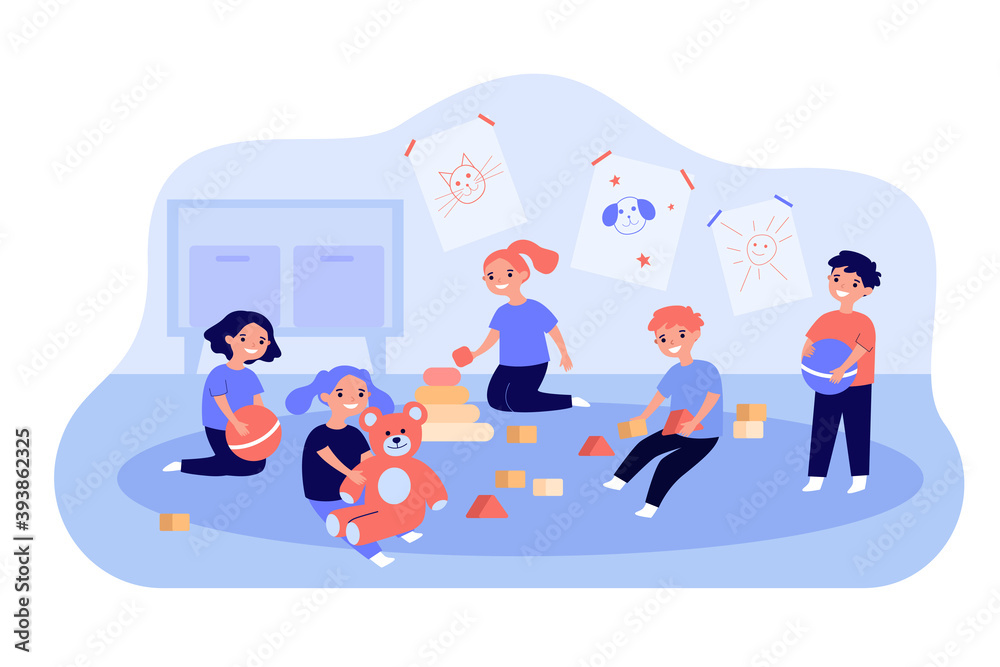 Cute children playing with toy cubes, balls and teddy bear in ...