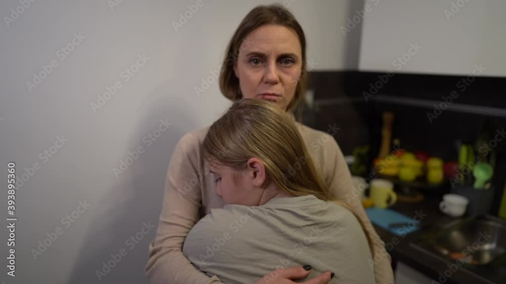 Stop domestic violence and abuse. Mother and daughter, victims of domestic violence are hugging ...