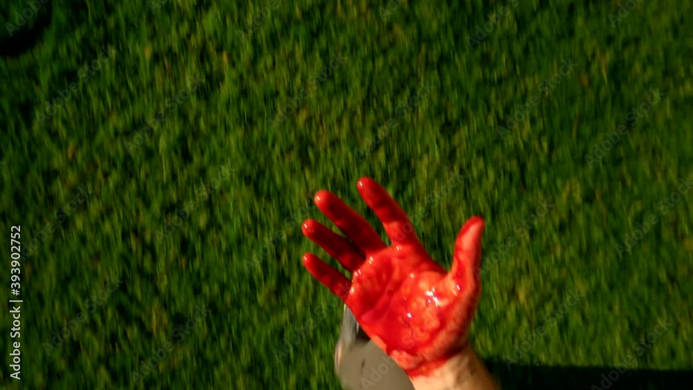 Horrified and scared man look down on hand covered in blood. Run away ...