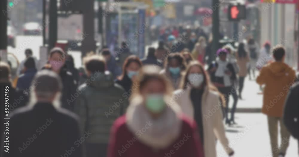 Crowd of people walking street wearing masks in New York City during ...