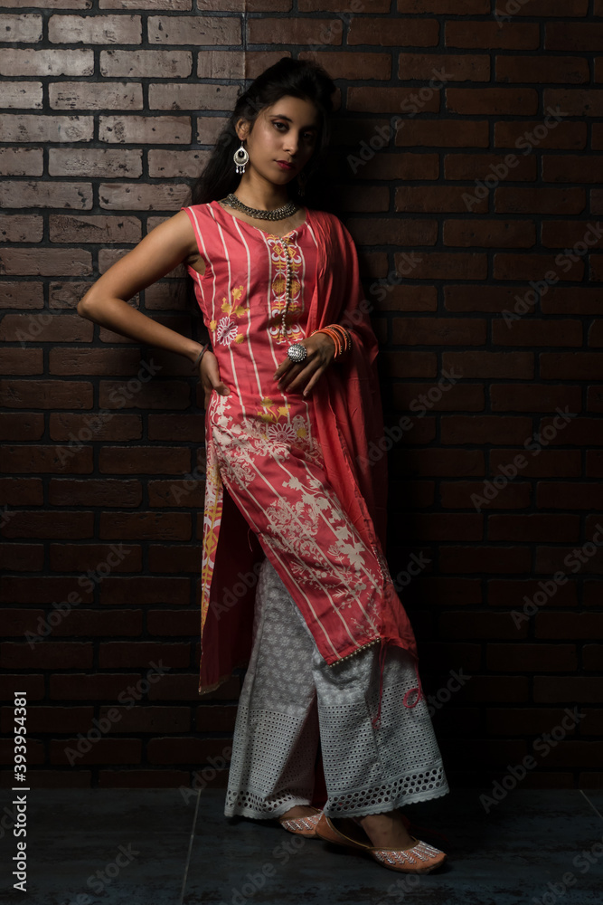 Indian girl with makeup and a fashionable hairstyle poses in Indian ...