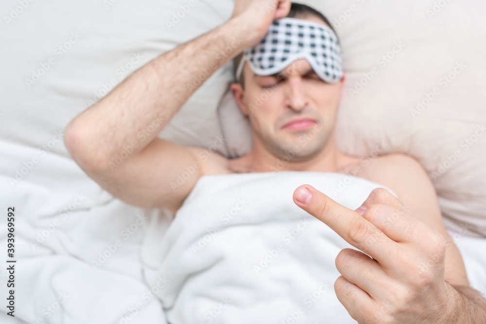 Sleepy man doesn't want to wake up, angry man shows middle finger on ...